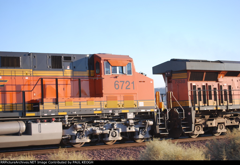 BNSF 6721 with the rising Sun ray's shining off BNSF 6721 BNSF Swoosh Logo Paint job passes me by!!!